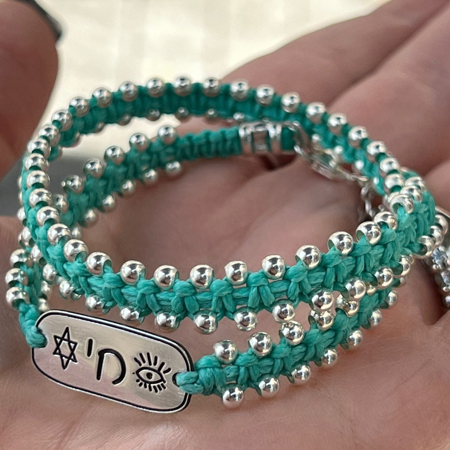 Macrame bracelet with silver beads and an Hebrew message 2 rows ...